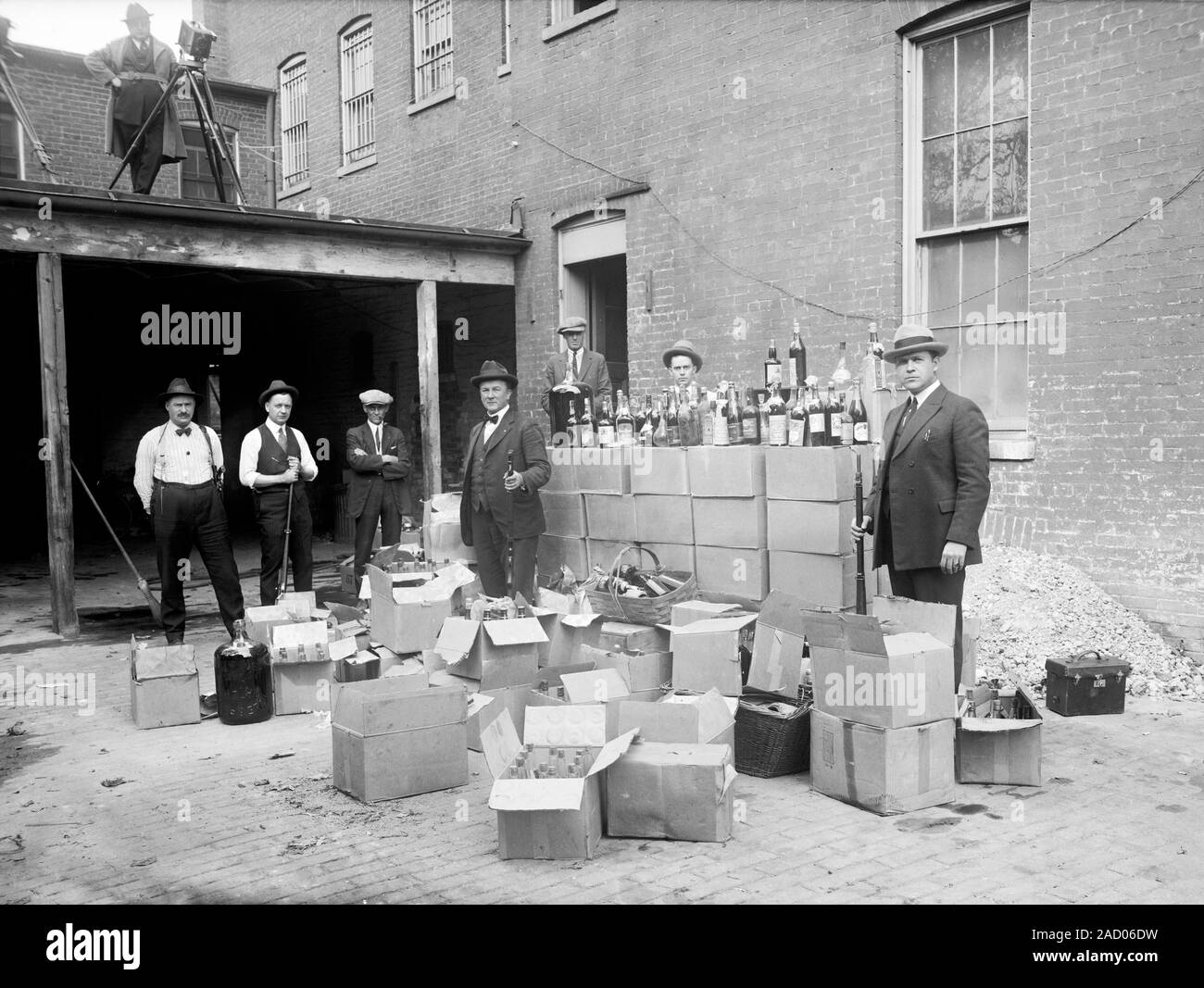 Law enforcement officers with alcoholic drinks confiscated in a liquor ...