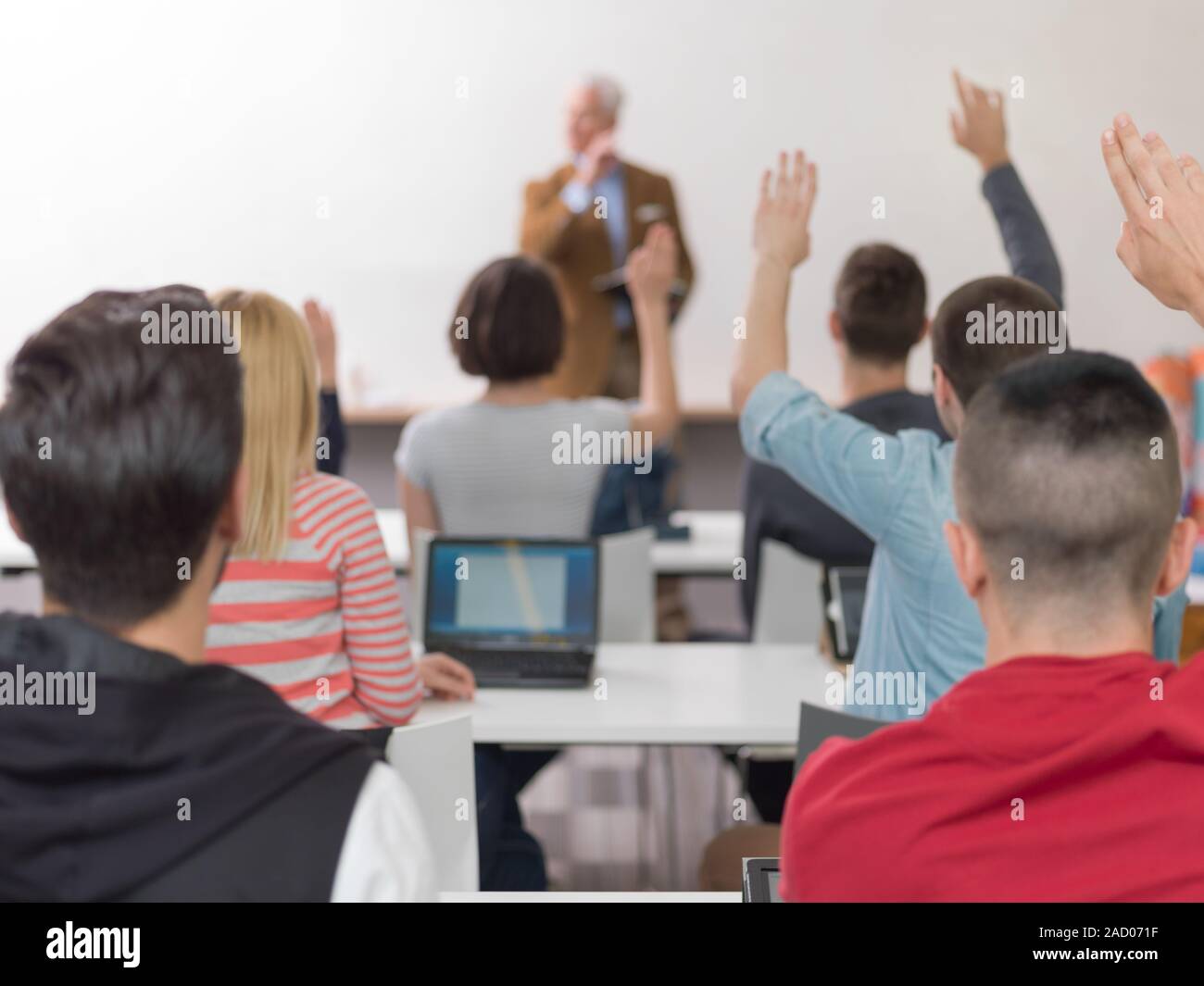 students group raise hands up on class Stock Photo - Alamy