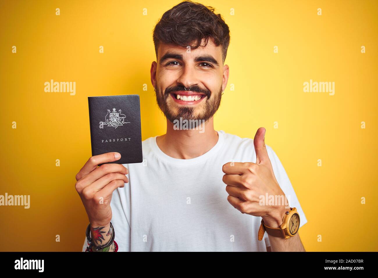 Young man with tattoo wearing Australia Australian passport over ...
