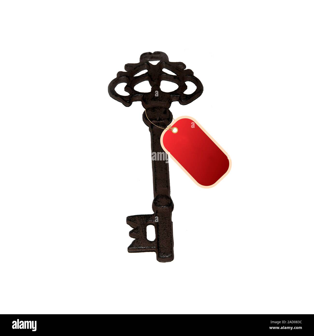 Antique vintage key. Blank red label hanging from key on a white ...