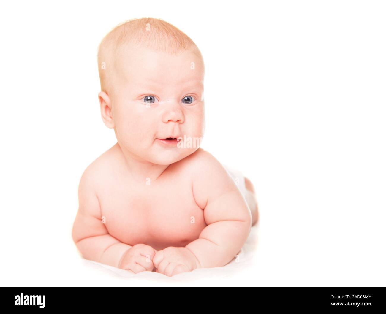 Happy young baby lying on tummy isolated Stock Photo - Alamy