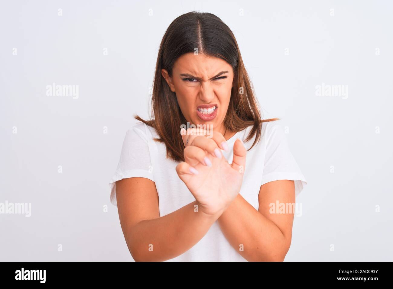 Portrait of beautiful and young brunette woman standing over isolated ...