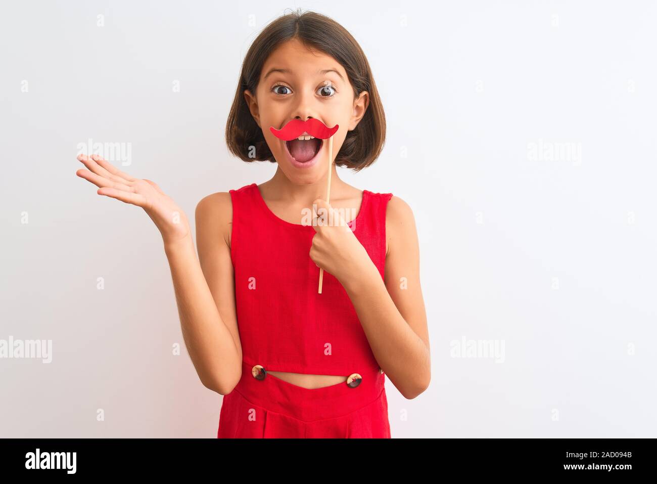 Beautiful child girl holding fanny party mustache standing over ...