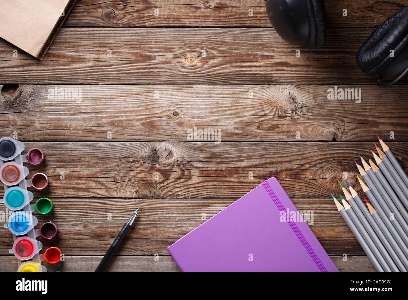 Watercolors, color pencils and sketchbook on wooden table. Flat lay ...