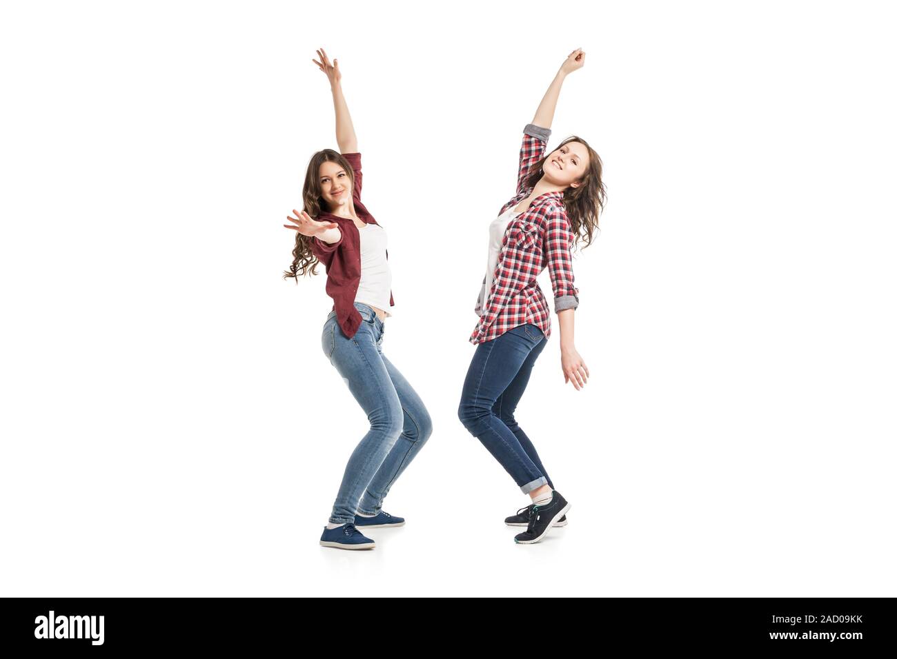 two young women dancing over white background Stock Photo - Alamy