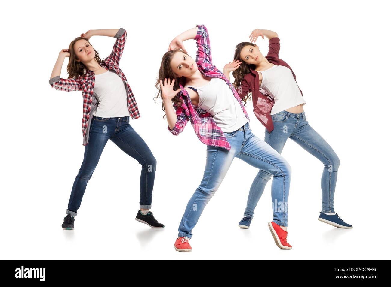 three young women dancing over white background Stock Photo - Alamy