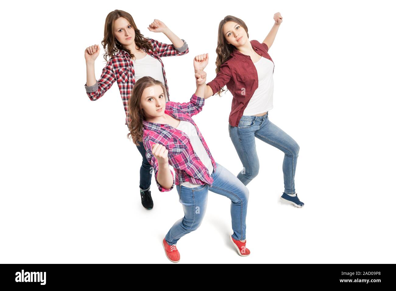 three young women dancing over white background Stock Photo - Alamy