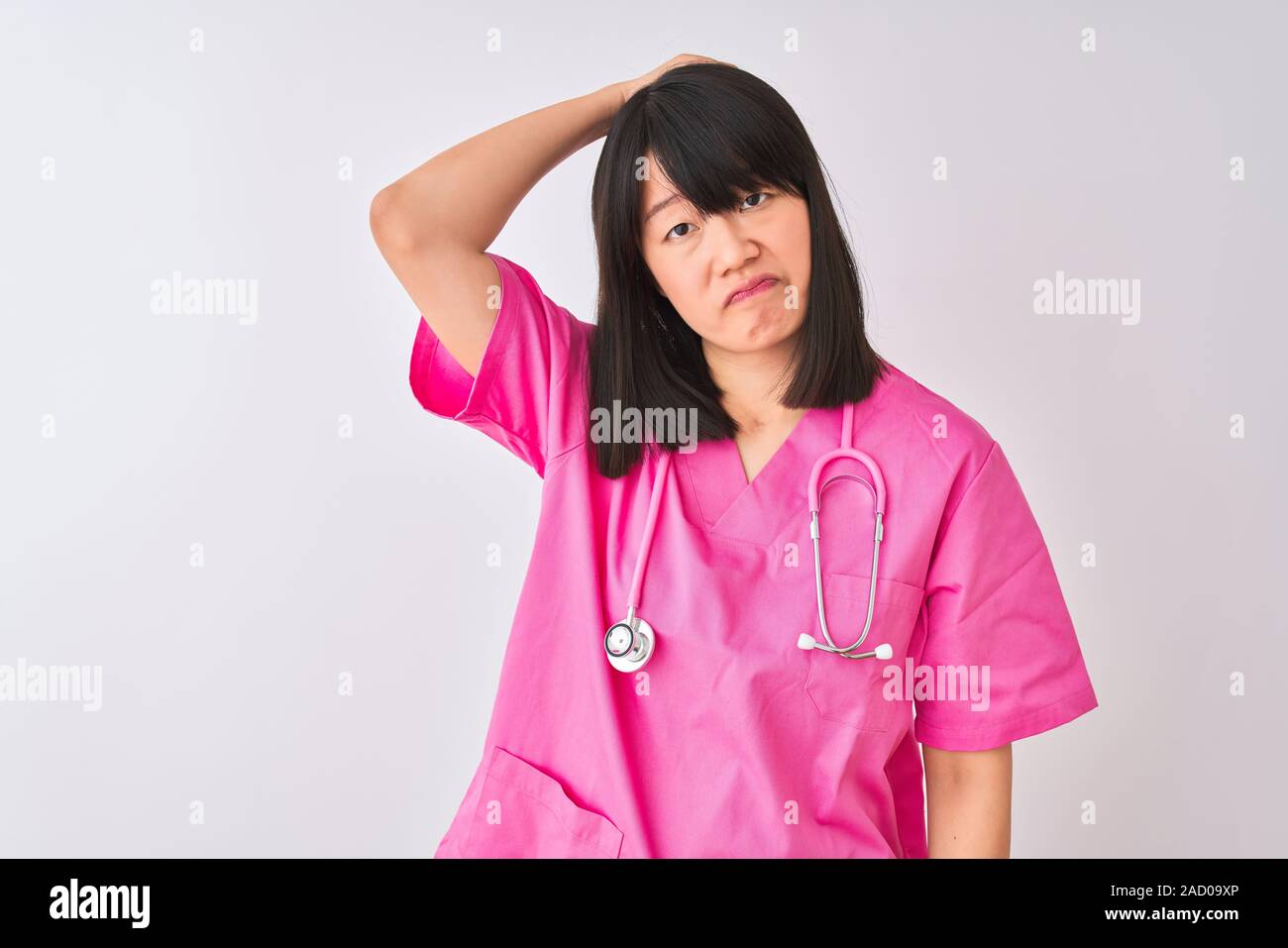 Young beautiful Chinese nurse woman wearing stethoscope over isolated ...