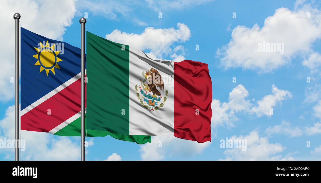 Namibia and Mexico flag waving in the wind against white cloudy blue ...