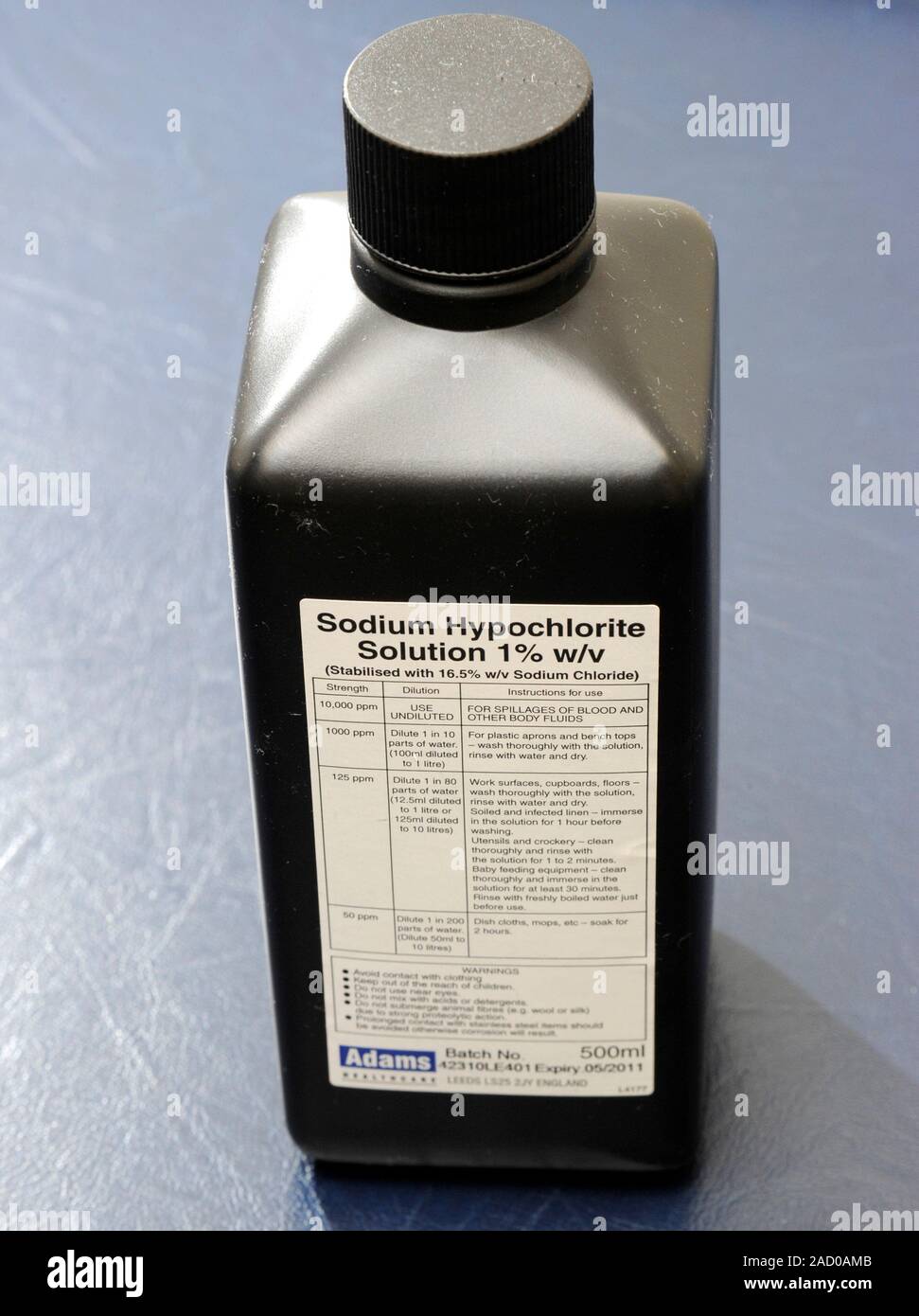 Sodium hypochlorite solution. Bottle containing a solution of sodium ...
