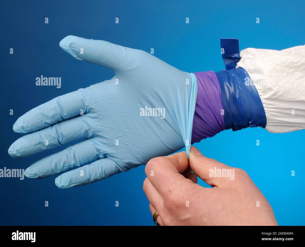 Double Gloving With Hazmat Suit Close Up Of A Person Putting On Two