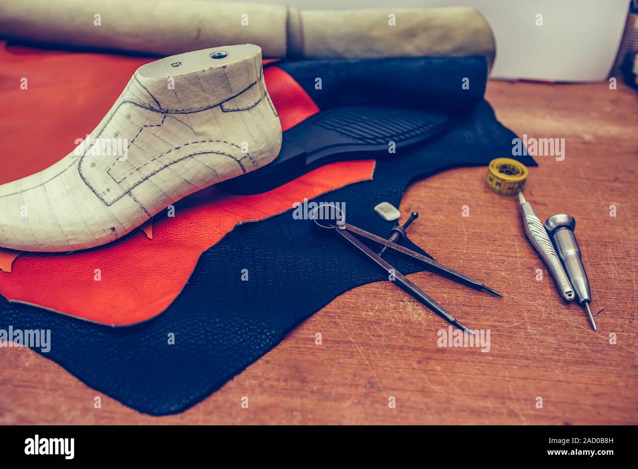 Shoemaker's work desk. Tools and leather at cobbler workplace. Man ...