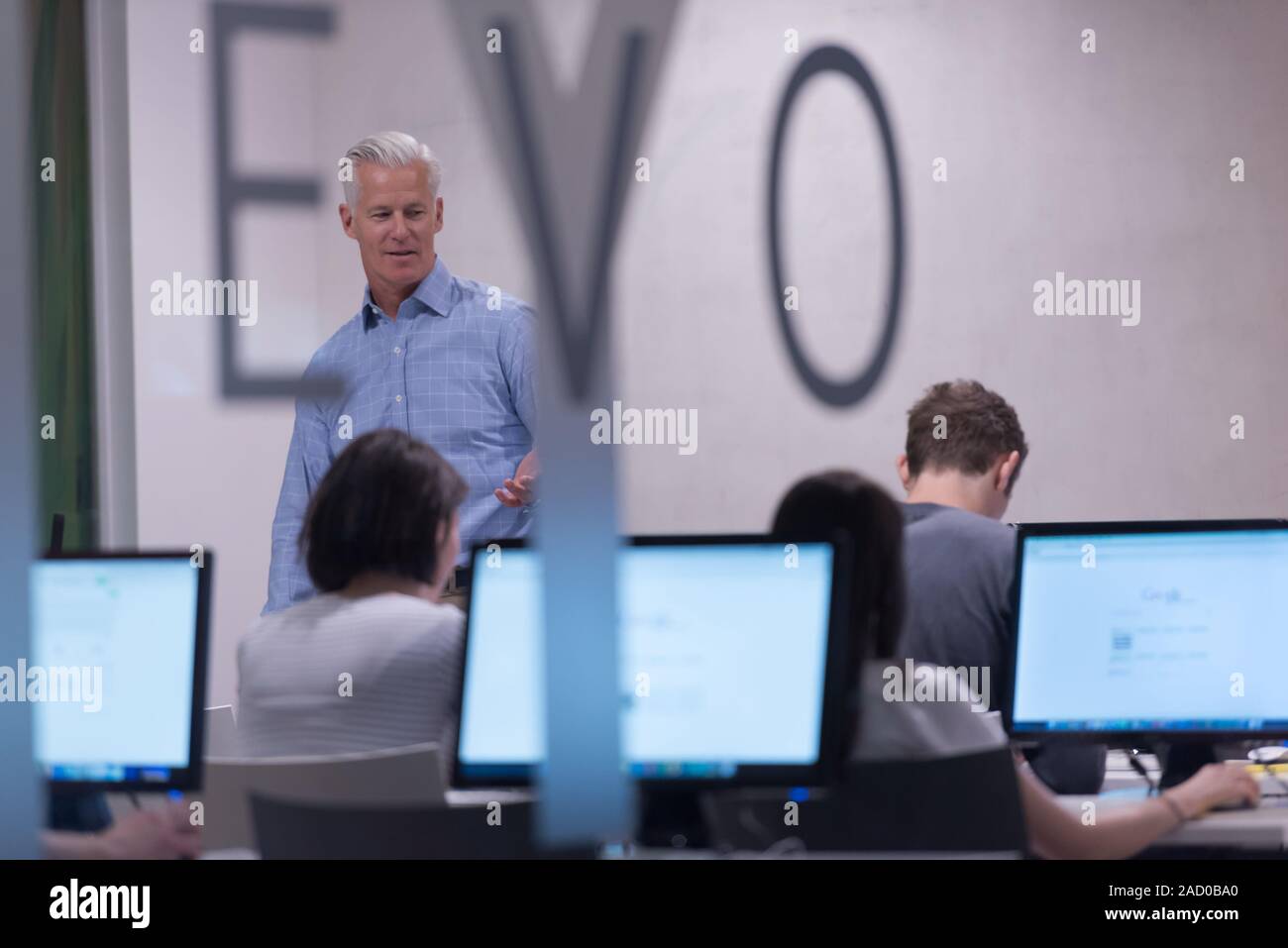 teacher and students in computer lab classroom Stock Photo - Alamy