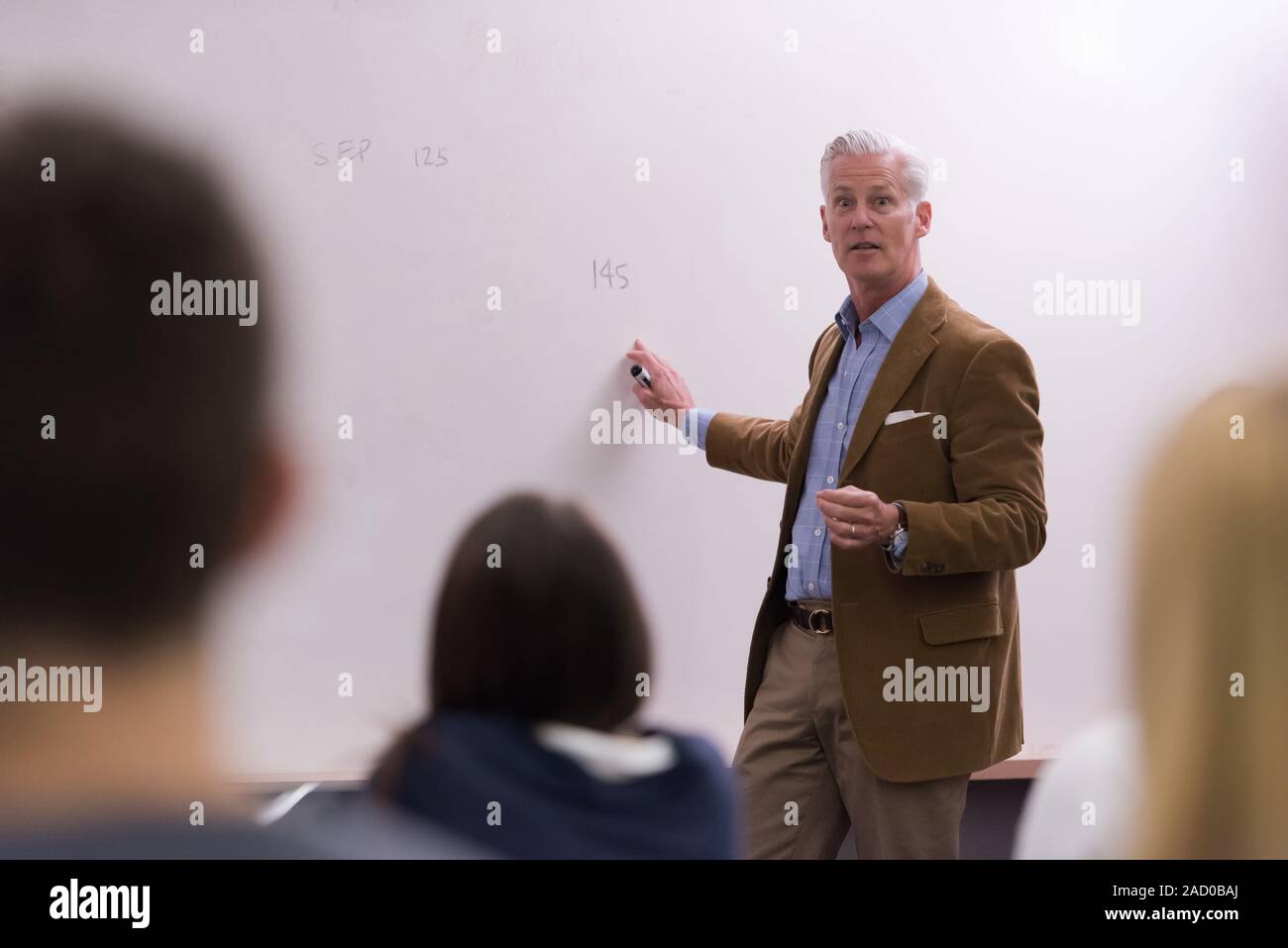 teacher with a group of hi school students in classroom Stock Photo - Alamy