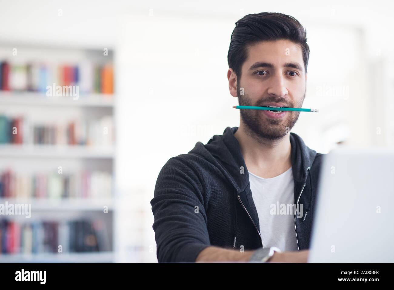 student in school library using laptop for research Stock Photo - Alamy