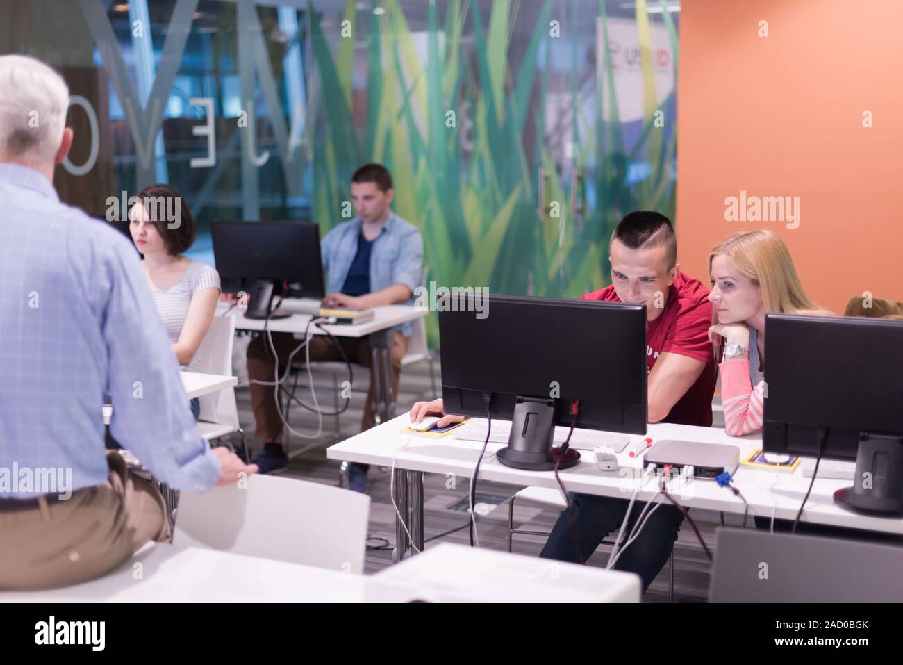 teacher and students in computer lab classroom Stock Photo - Alamy