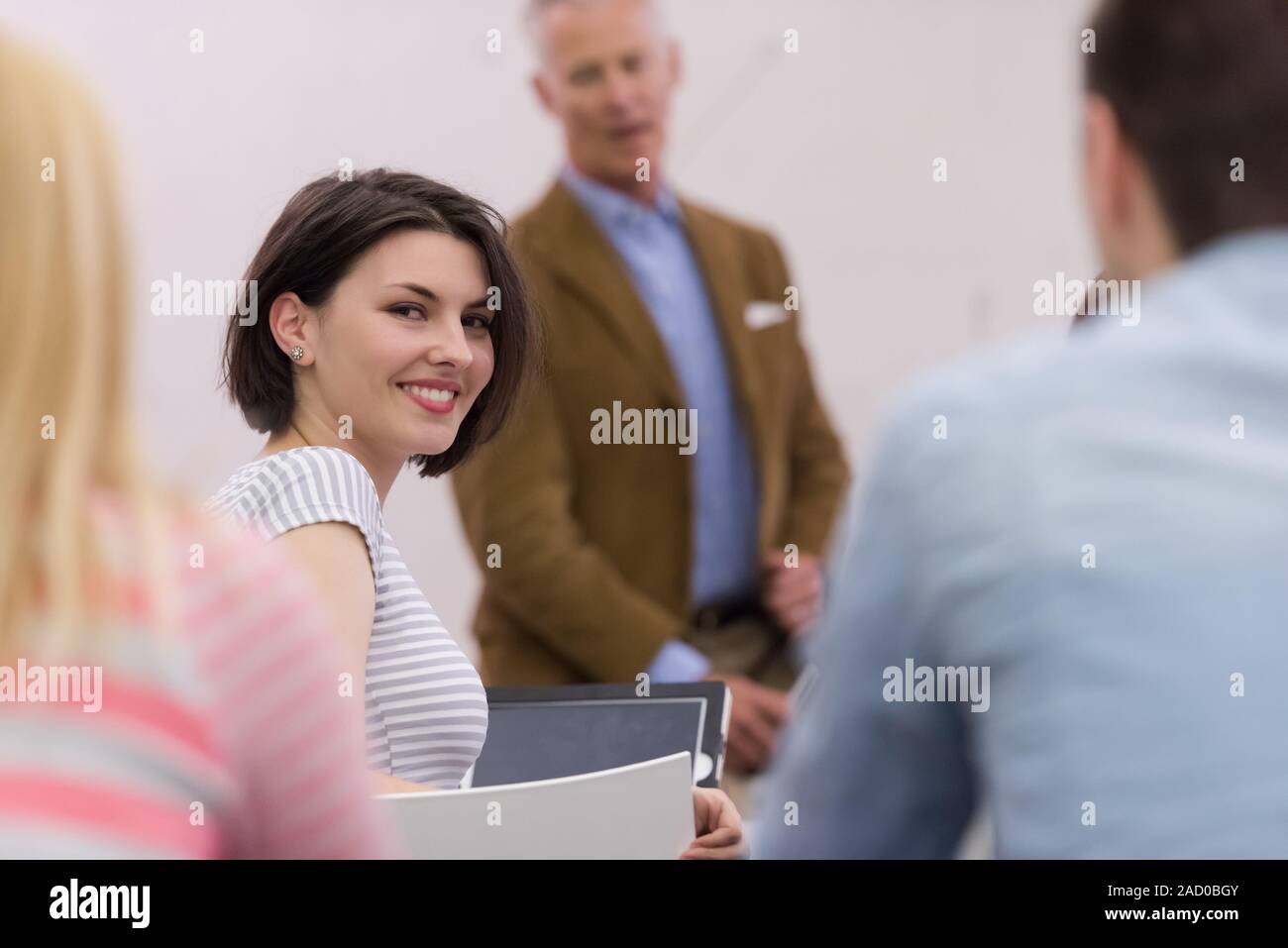teacher with a group of hi school students in classroom Stock Photo - Alamy