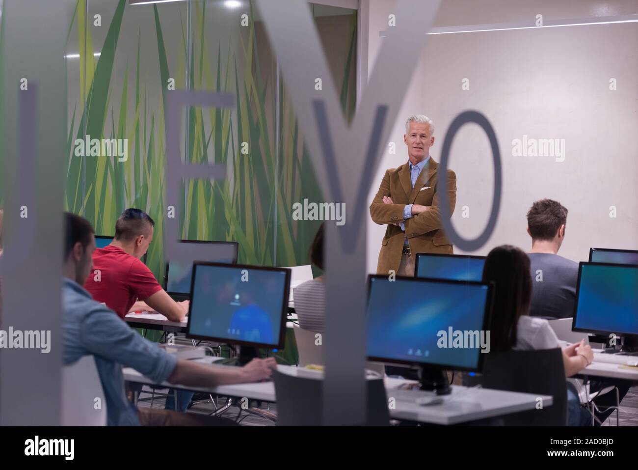 teacher and students in computer lab classroom Stock Photo - Alamy