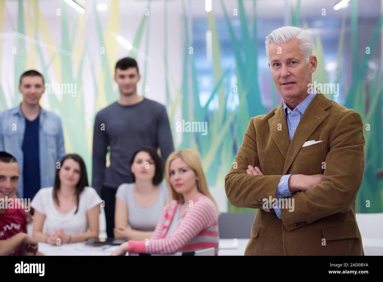 portrait of teacher with students group in background Stock Photo - Alamy