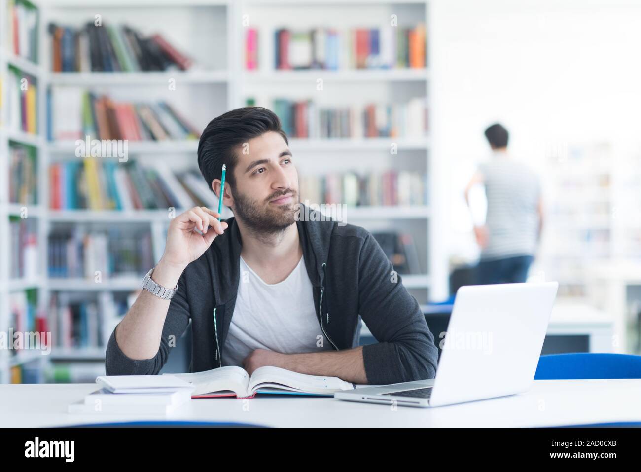student in school library using laptop for research Stock Photo - Alamy