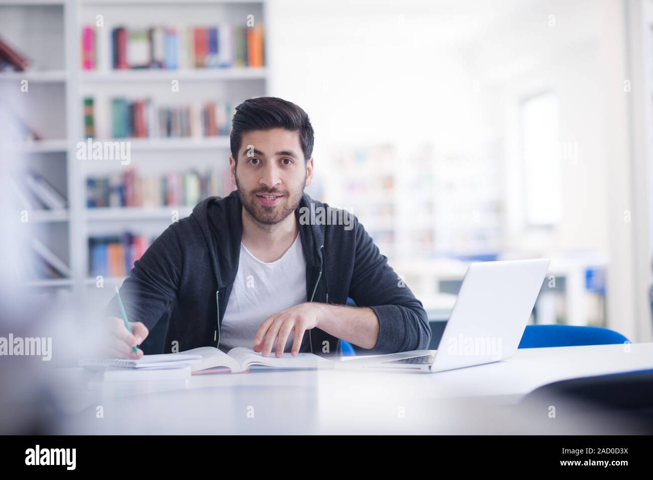 student in school library using laptop for research Stock Photo - Alamy