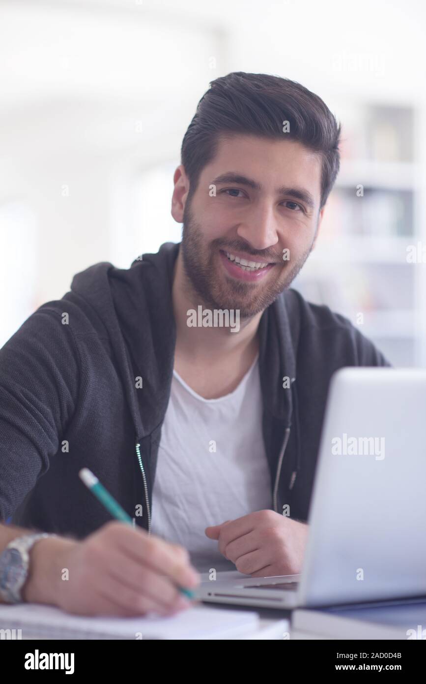 student in school library using laptop for research Stock Photo - Alamy
