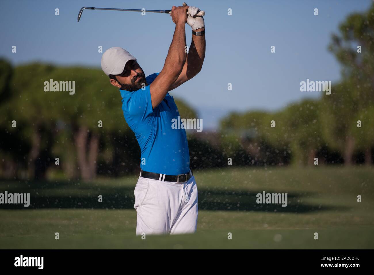 pro golfer hitting a sand bunker shot Stock Photo - Alamy