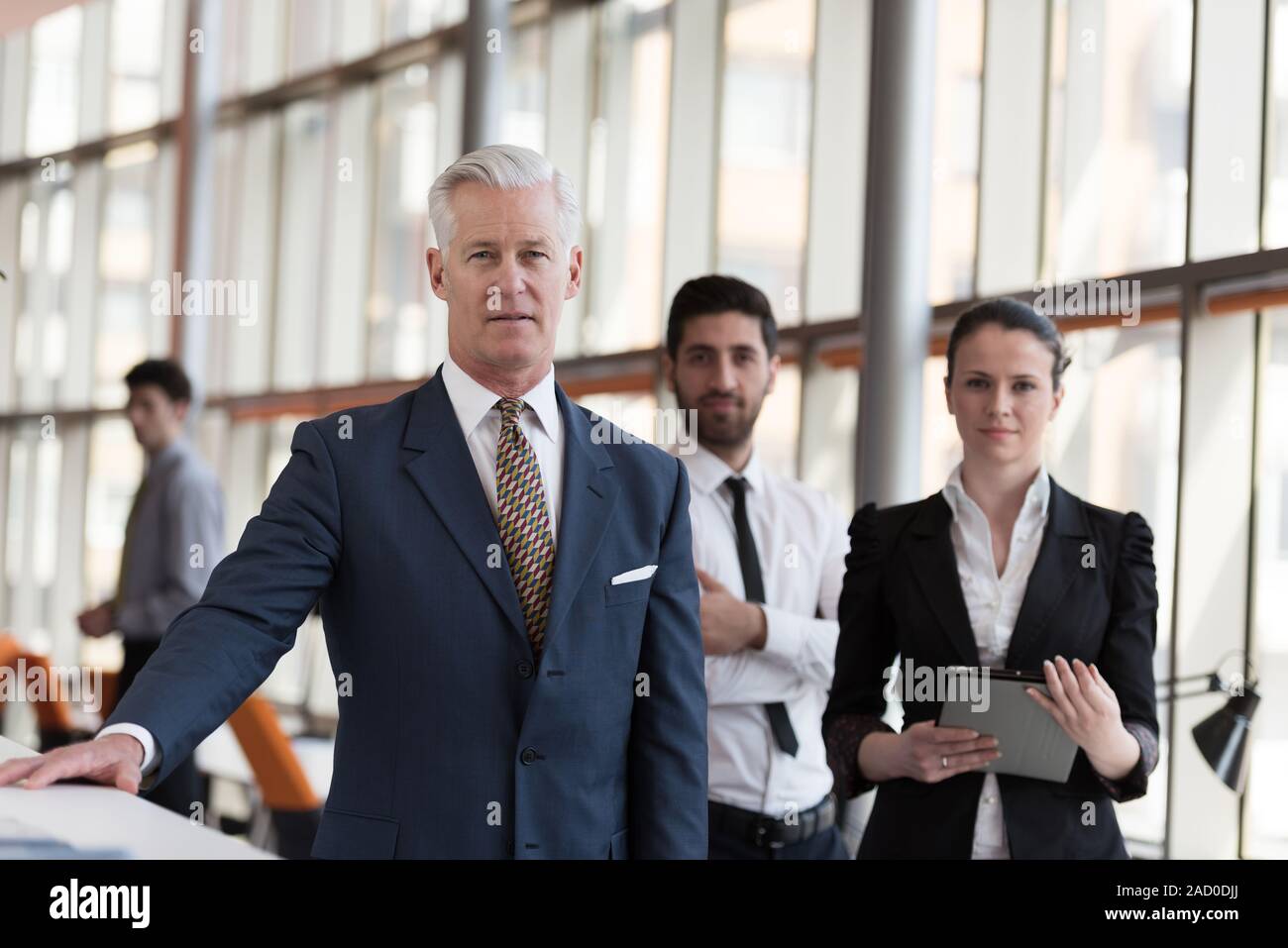 portrait of senior Businessman as leader with group of people in ...