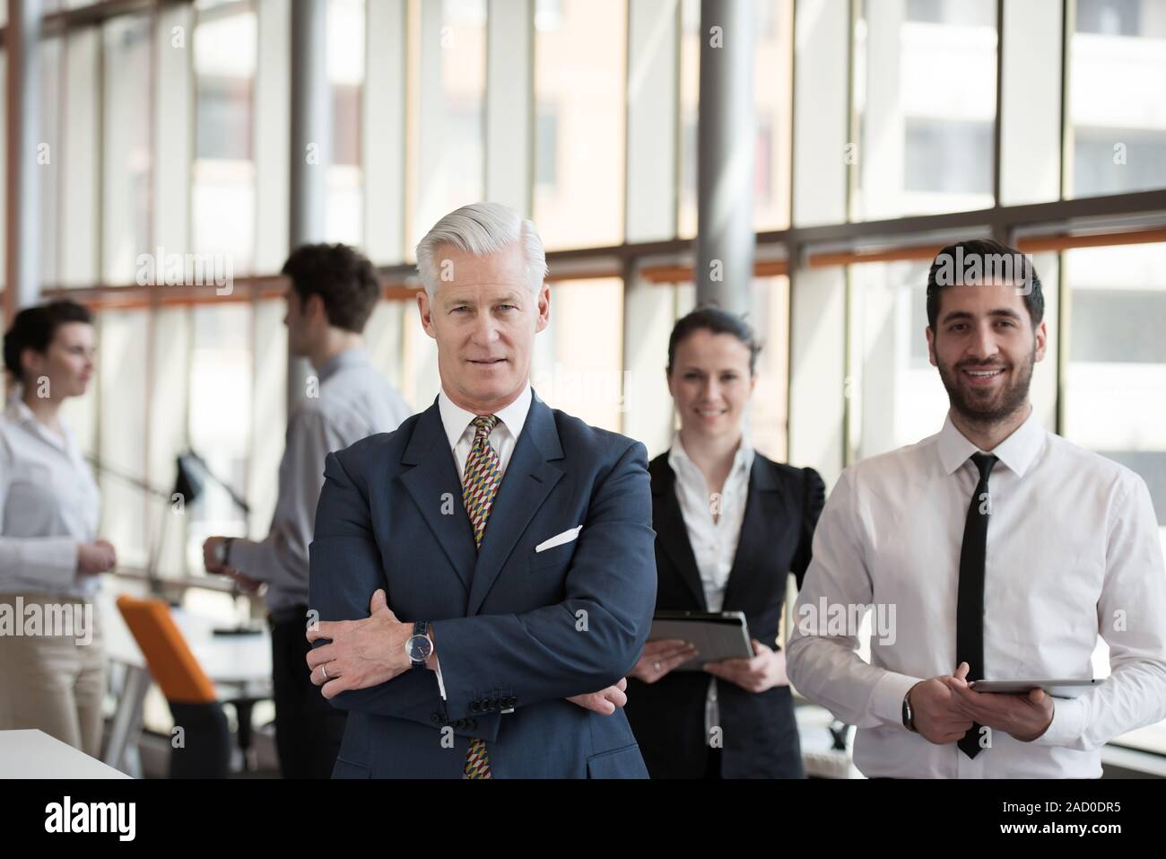 portrait of senior Businessman as leader with group of people in ...