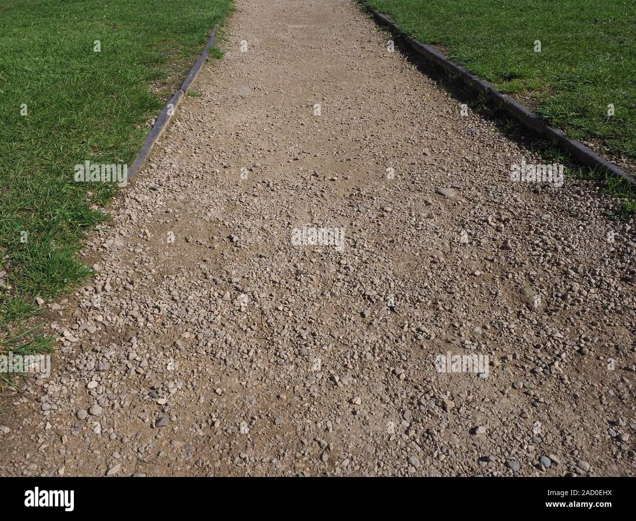 earth and pebble path amidst the meadow useful as a background Stock ...