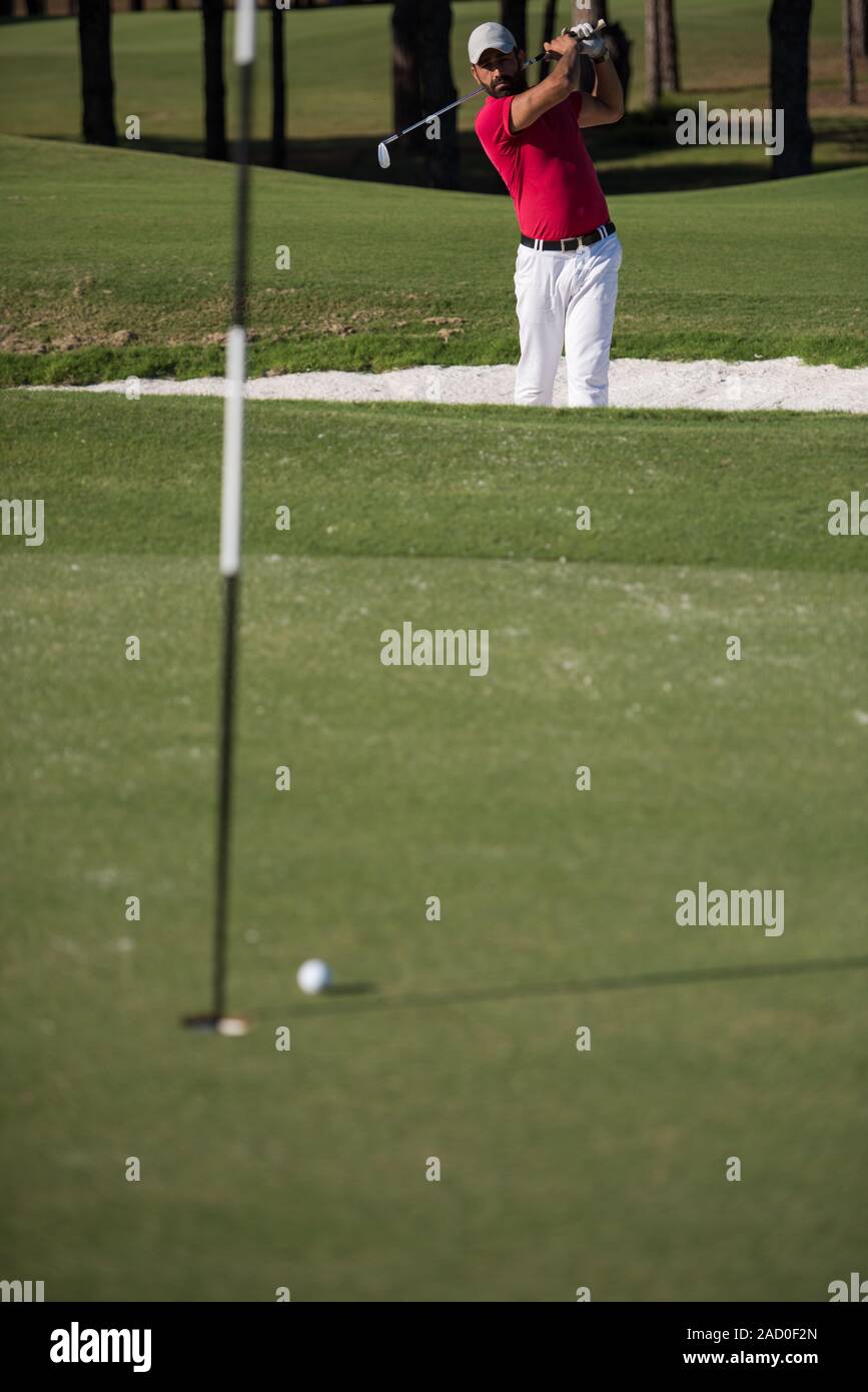 golfer hitting a sand bunker shot Stock Photo - Alamy