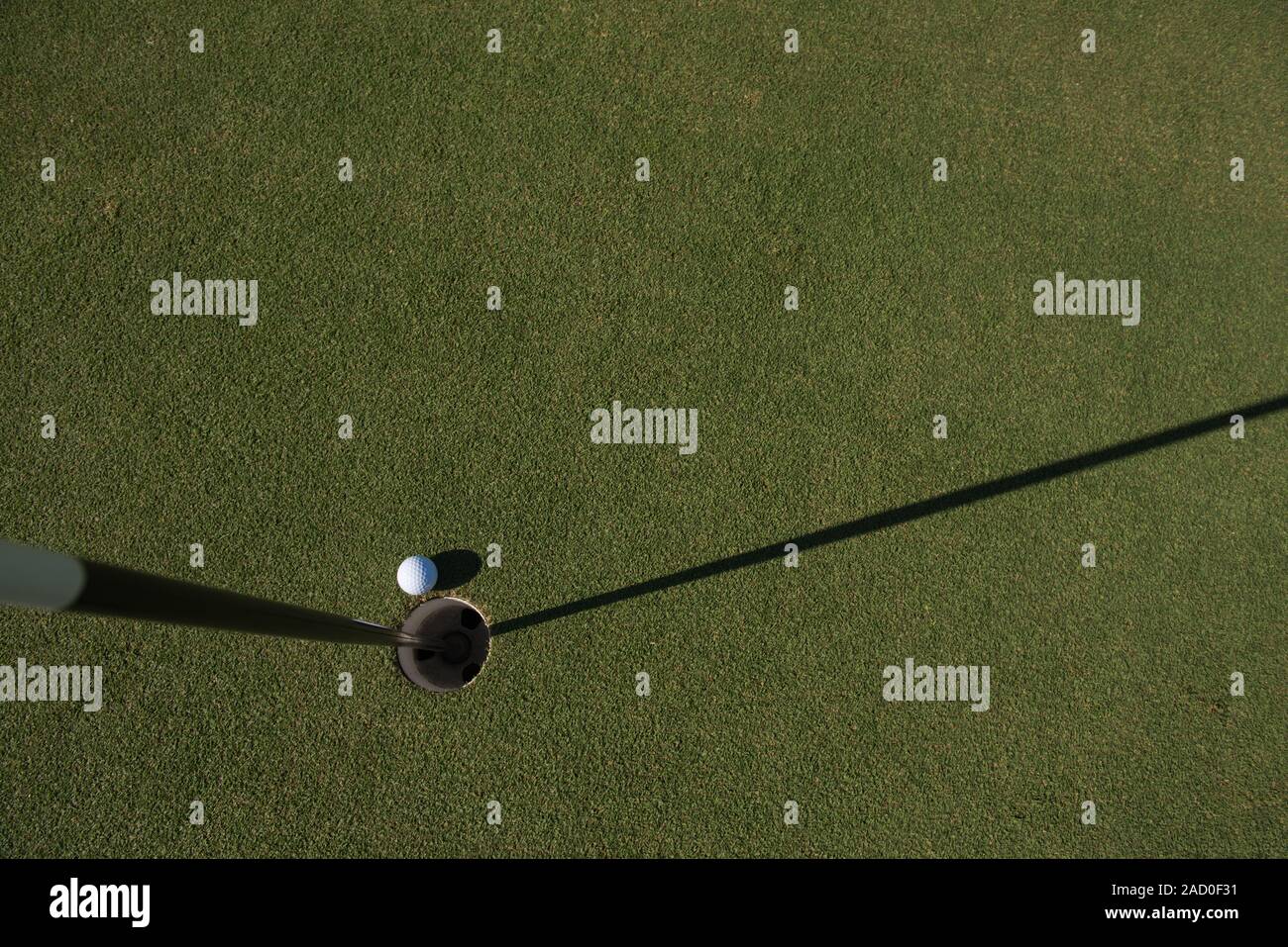 top view of golf ball in the hole Stock Photo - Alamy
