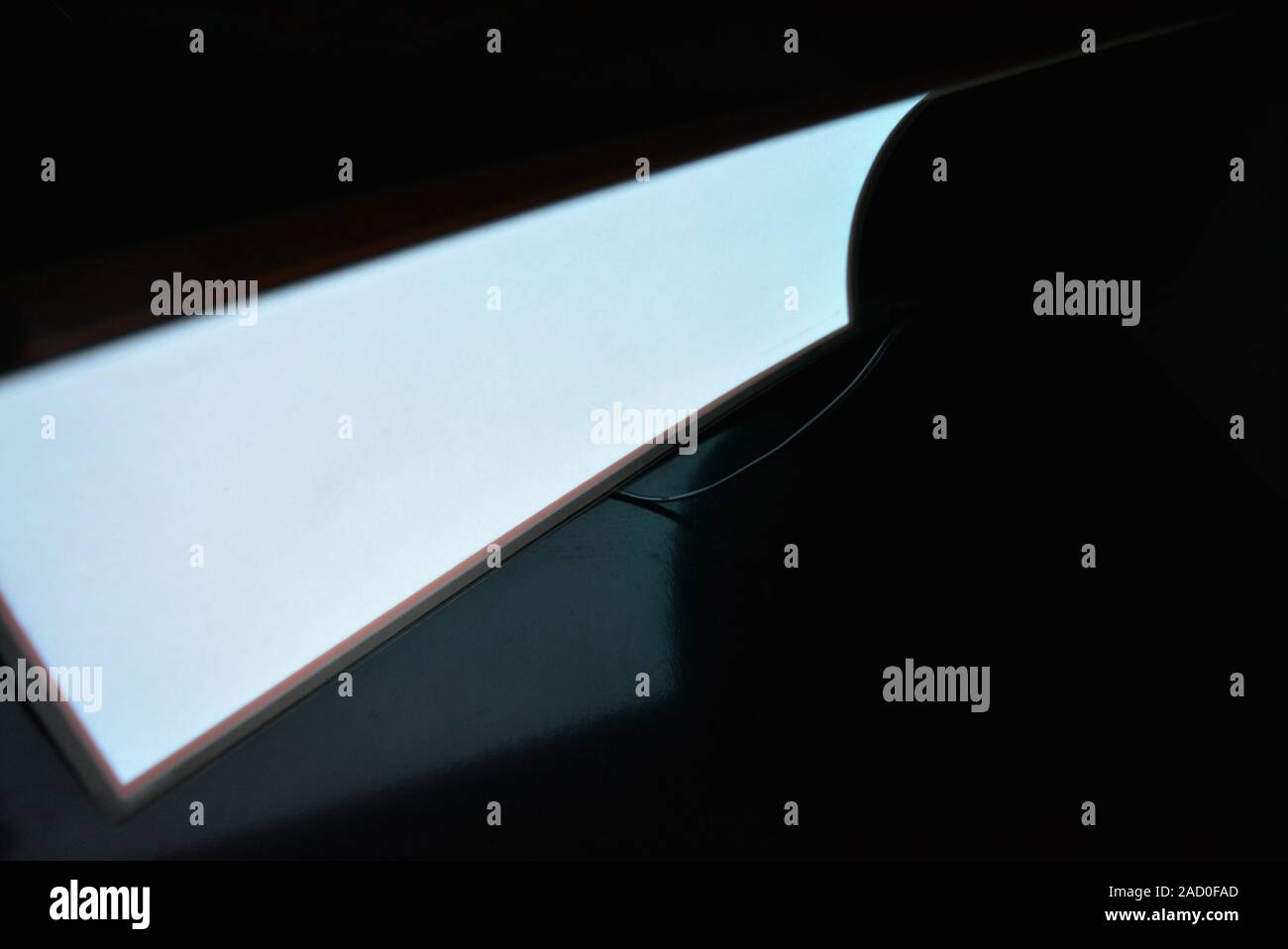 Luminous A4 paper with an electroluminescent coating is located in ...