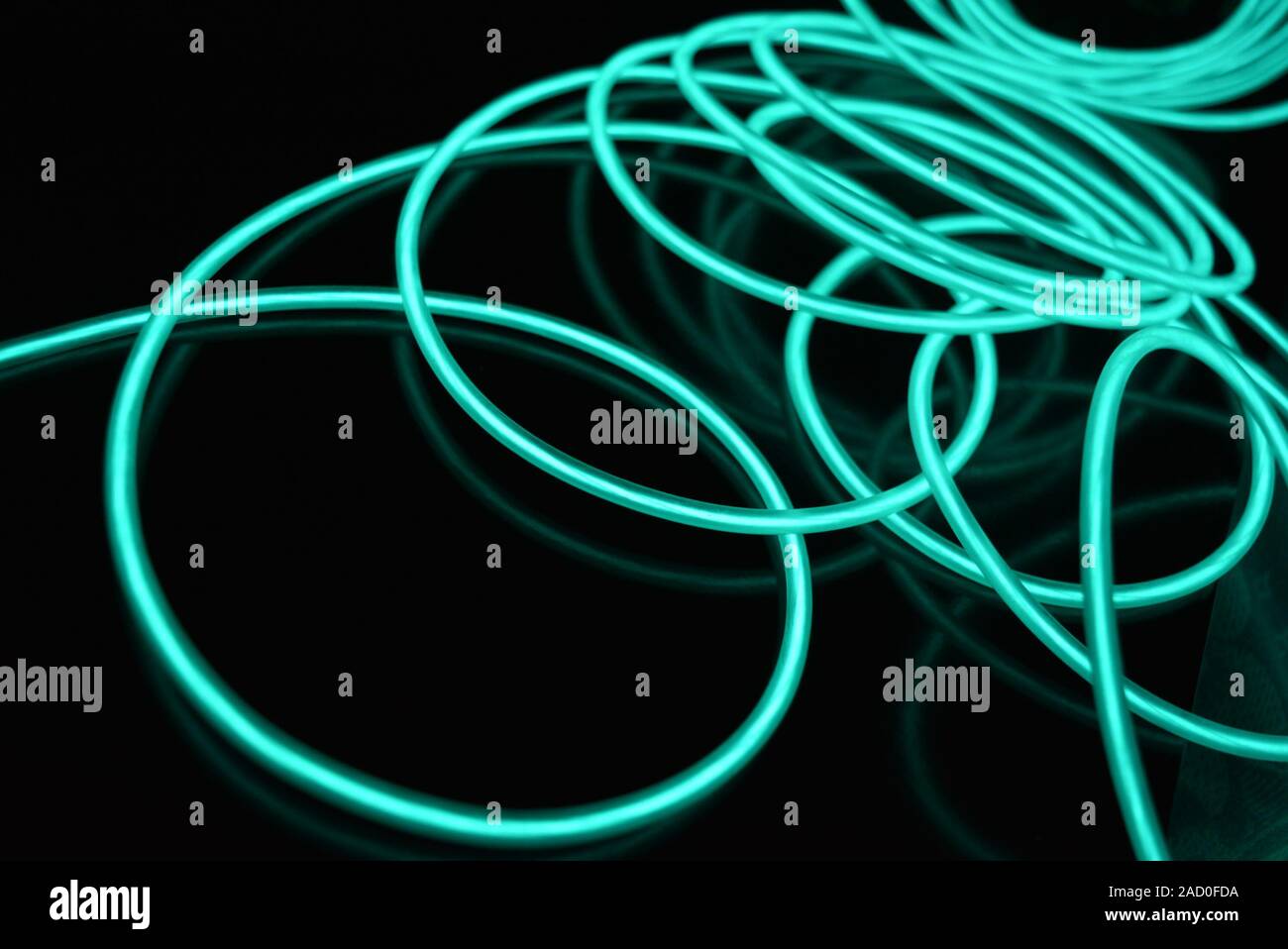 Unusual bright wires made of turquoise-colored material glowing at ...