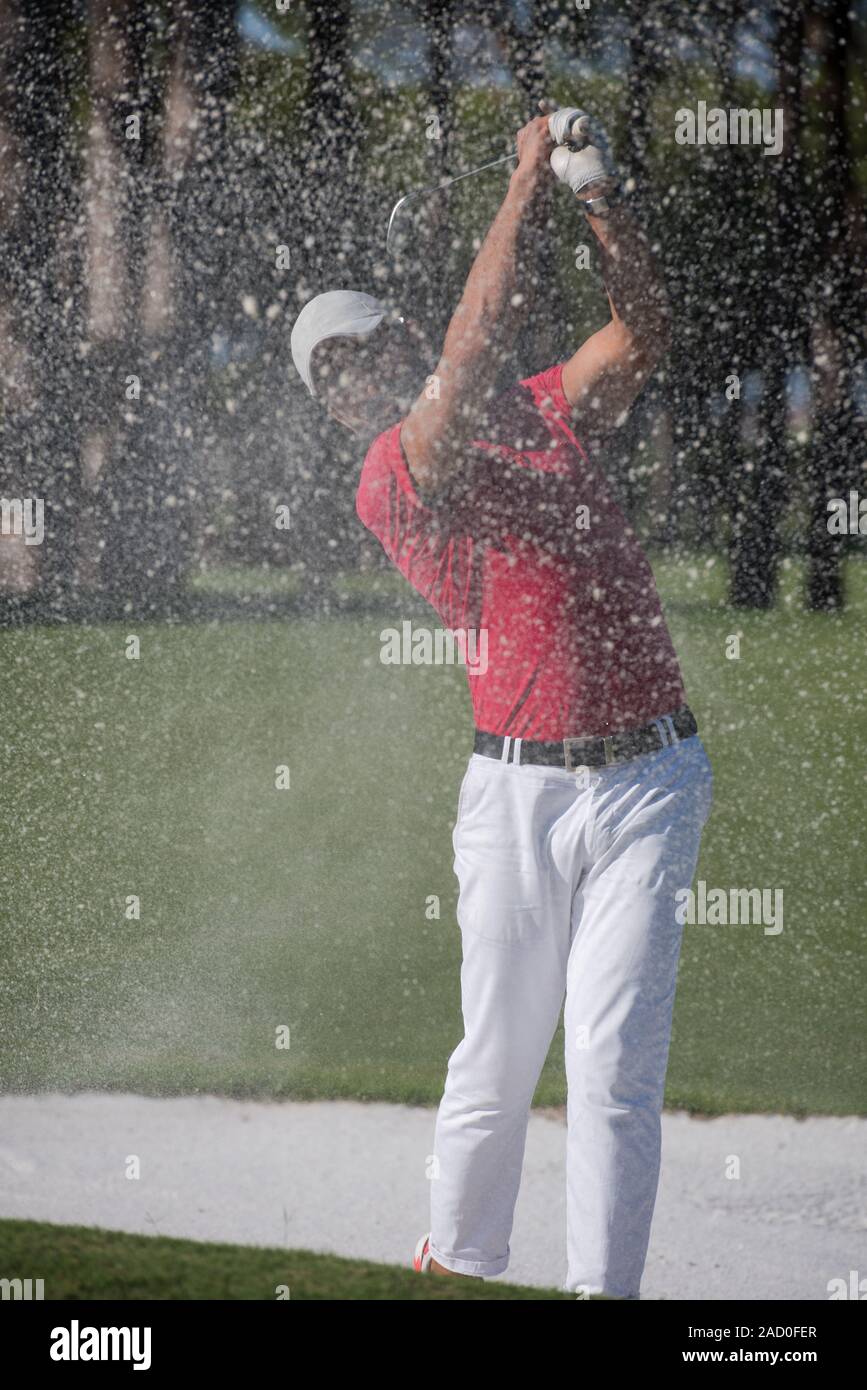 golfer hitting a sand bunker shot Stock Photo - Alamy