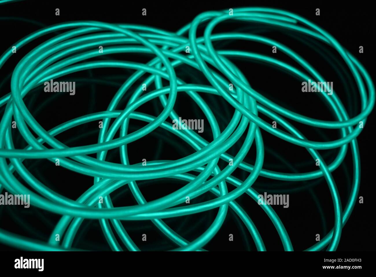 Unusual bright wires made of turquoise-colored material glowing at ...