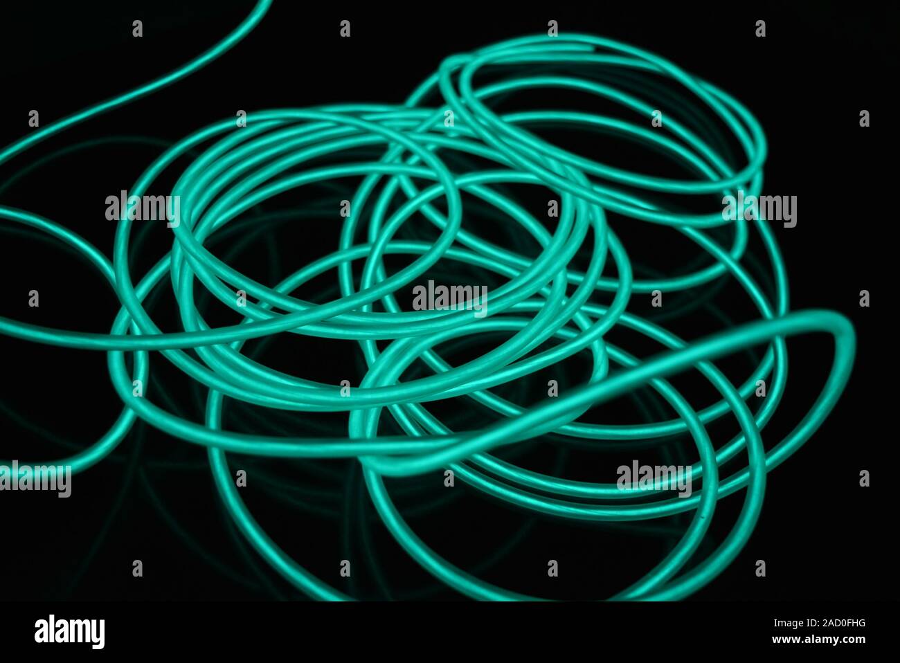Unusual bright wires made of turquoise-colored material glowing at ...