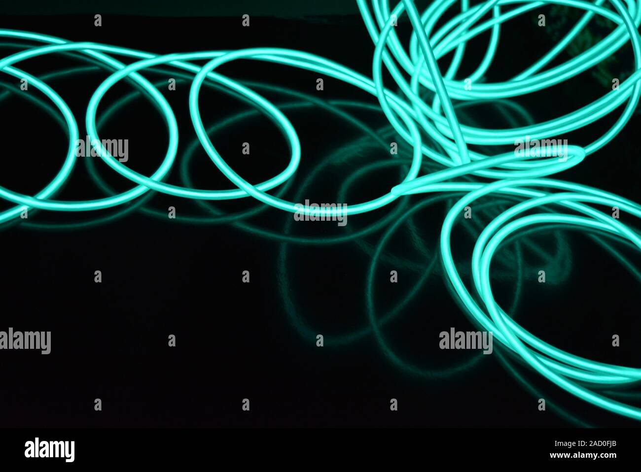 Unusual bright wires made of turquoise-colored material glowing at ...