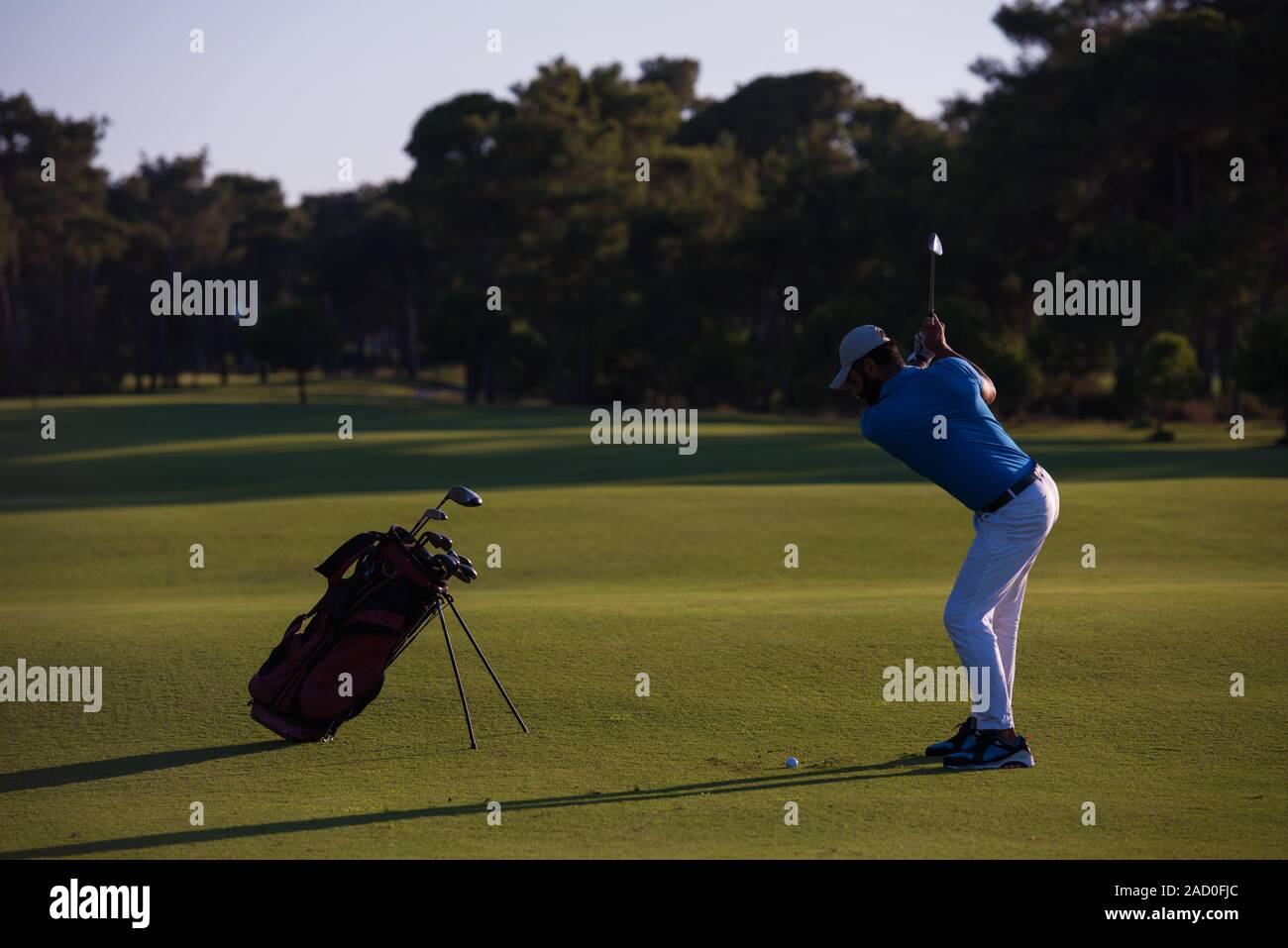 golfer hitting long shot Stock Photo - Alamy