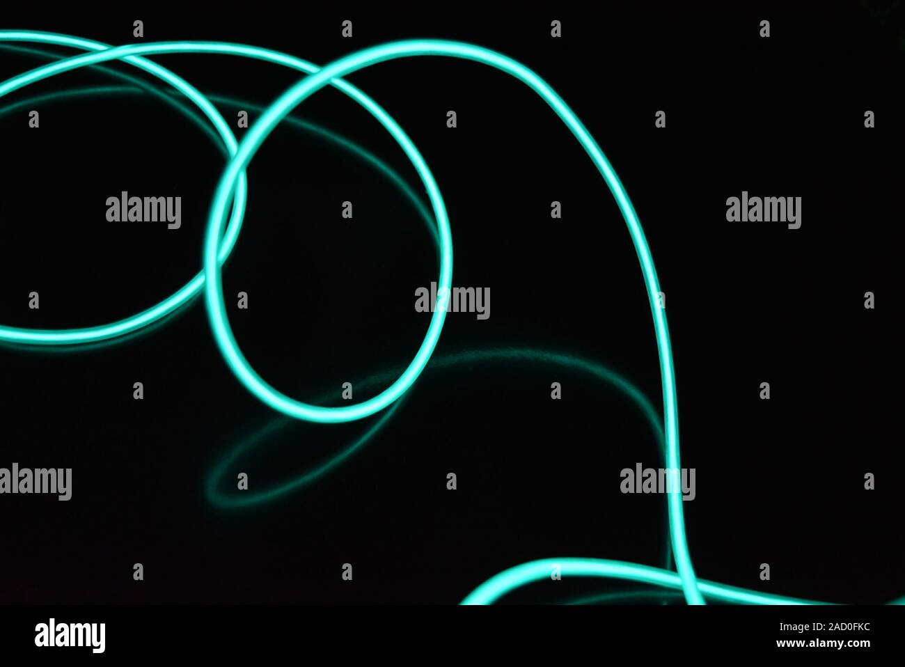 Unusual bright wires made of turquoise-colored material glowing at ...