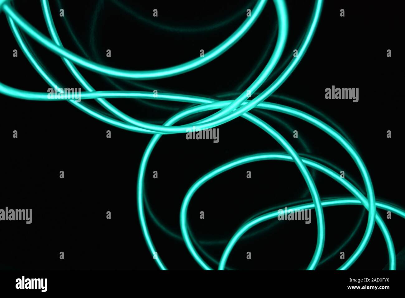 Unusual bright wires made of turquoise-colored material glowing at ...