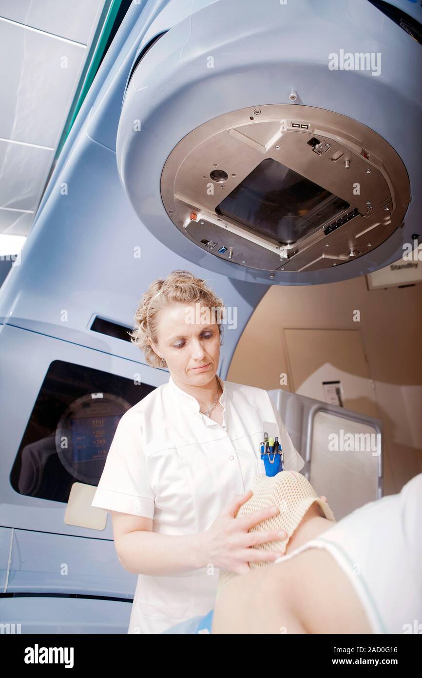 Radiotherapy treatment. Patient undergoing radiotherapy (radiation ...