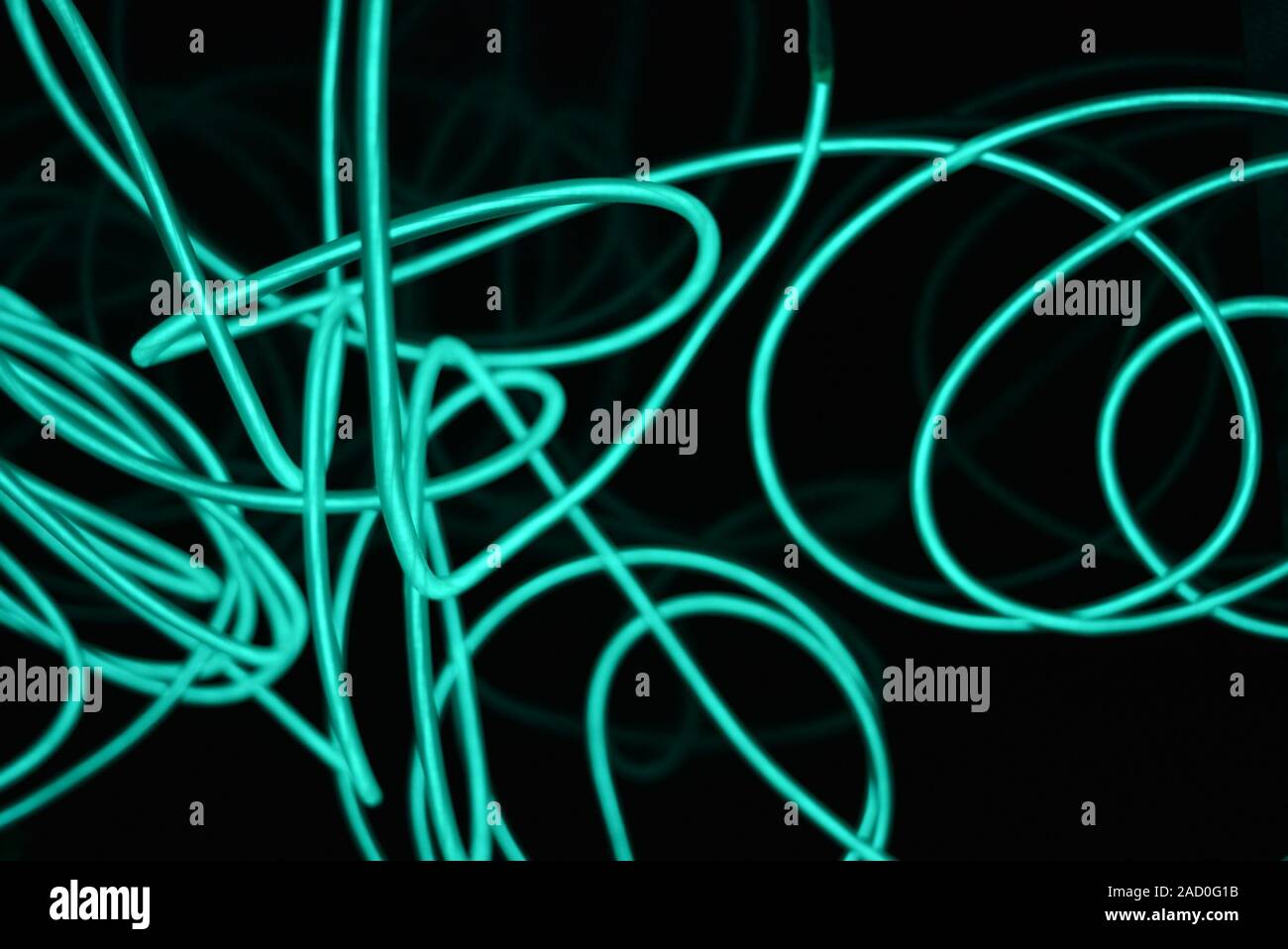 Unusual bright wires made of turquoise-colored material glowing at ...