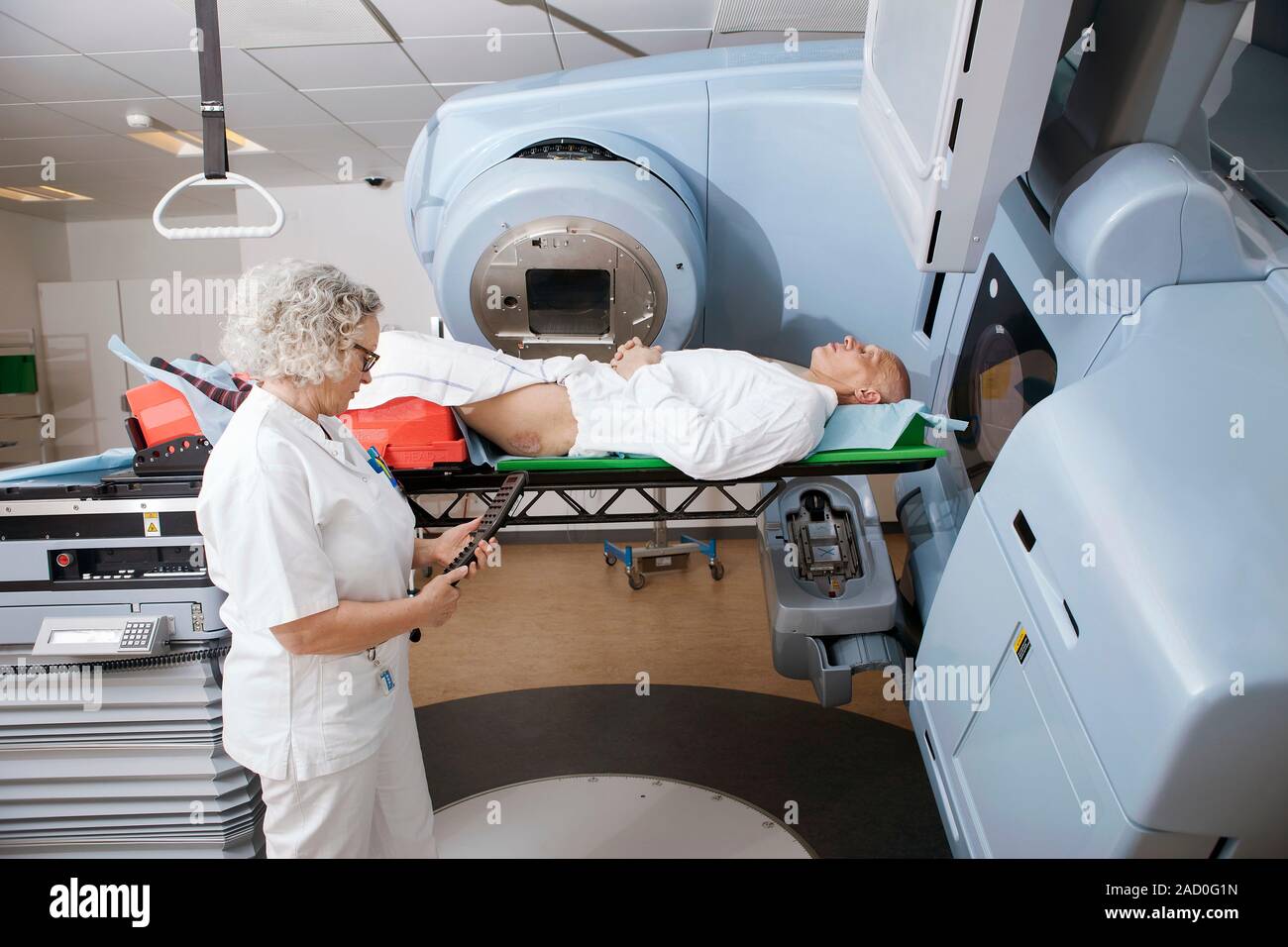 Radiotherapy treatment. Patient undergoing radiotherapy (radiation ...