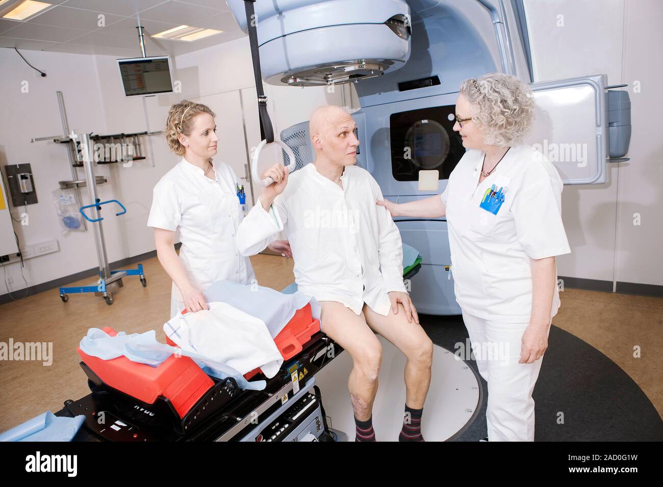 Radiotherapy treatment. Patient undergoing radiotherapy (radiation ...