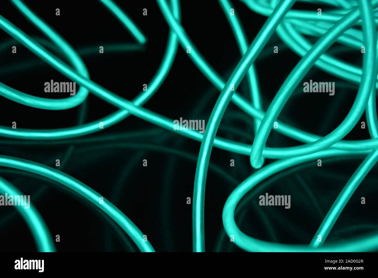 Unusual bright wires made of turquoise-colored material glowing at ...