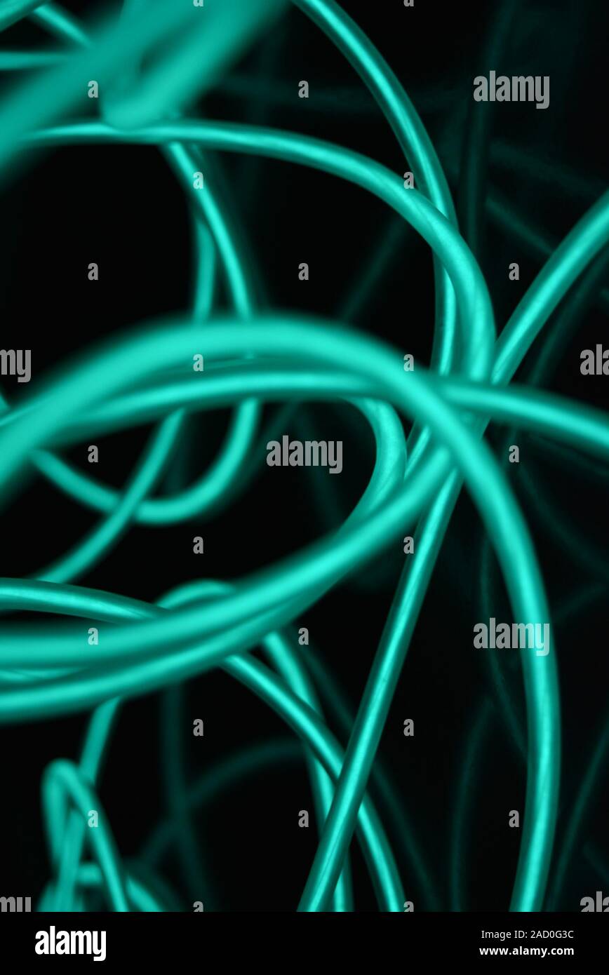 Unusual bright wires made of turquoise-colored material glowing at ...
