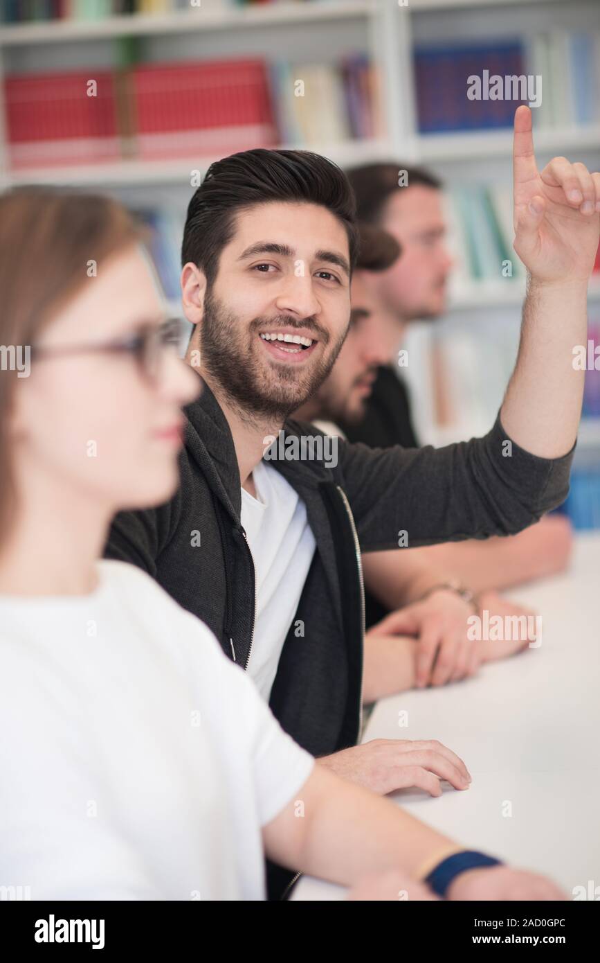 group of students raise hands up Stock Photo - Alamy