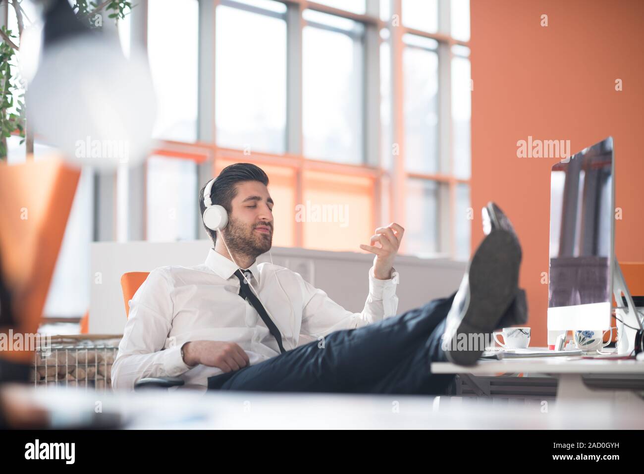 relaxed young Business man at office Stock Photo - Alamy