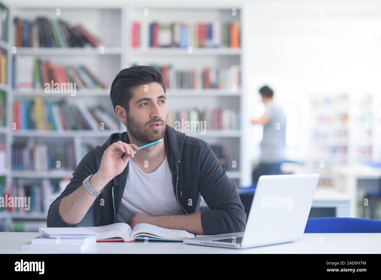 student in school library using laptop for research Stock Photo - Alamy